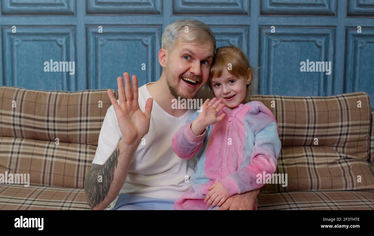 Father and little child daughter kid smiling, joyfully greeting, waving ...