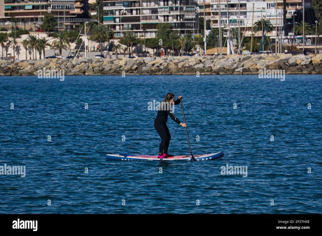 paddle surfing on the beach, located in Alicante, Spain. View Stock ...