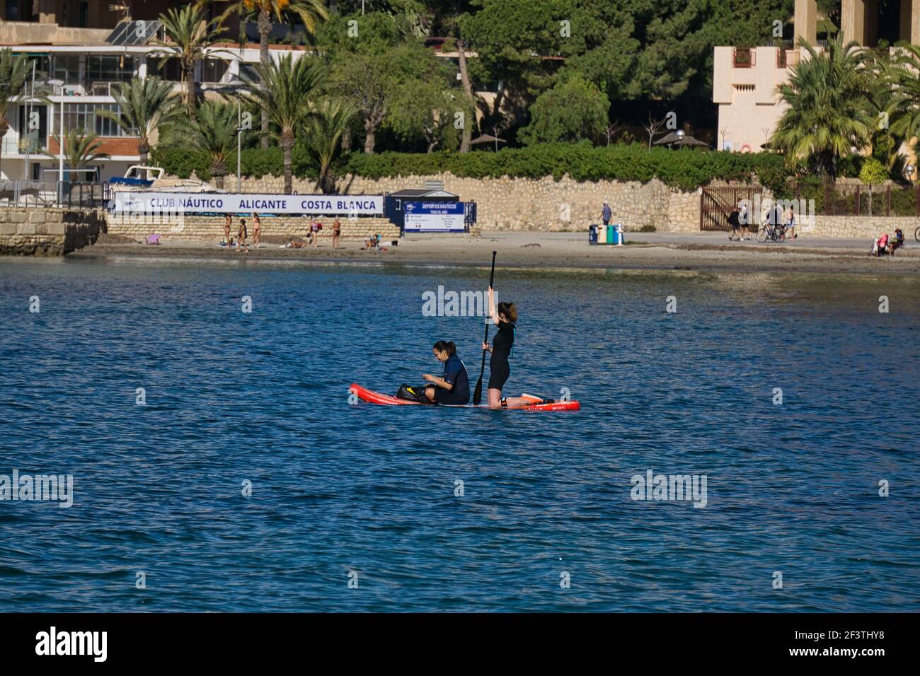paddle surfing on the beach, located in Alicante, Spain. View Stock ...