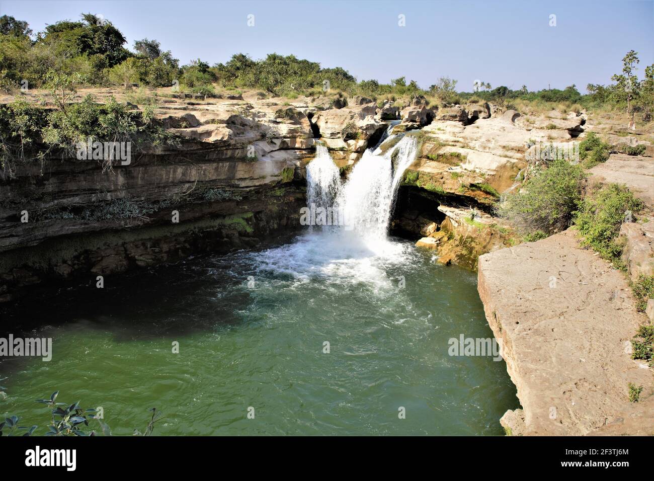 A top view shot of a beautiful waterfall that fills the natural pool ...