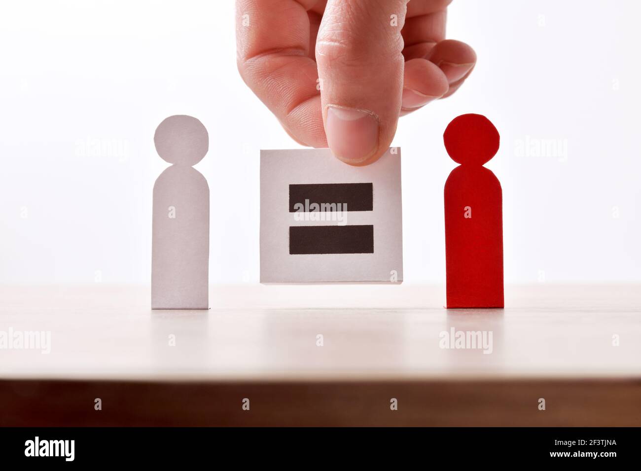 Equality between racial diversity and hand holding sign with equal sign ...