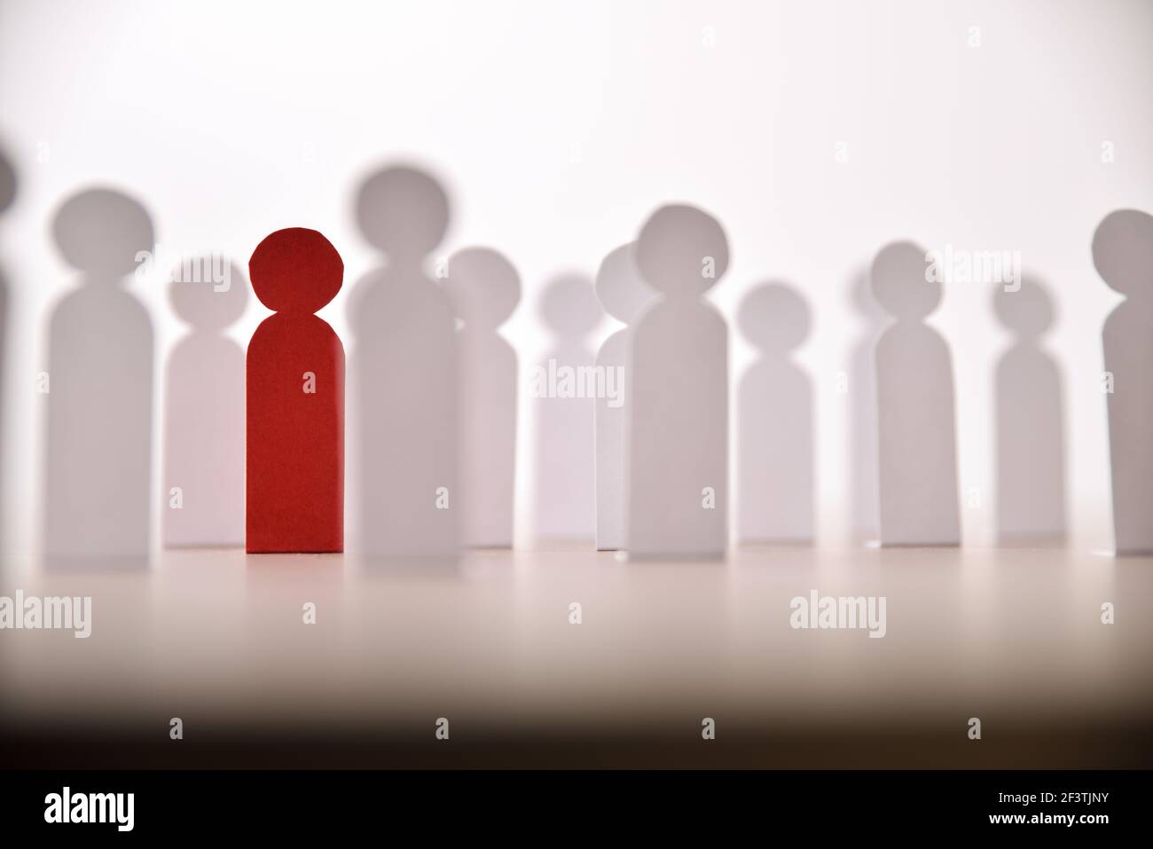 Social discrimination concept with many little paper men and a ...