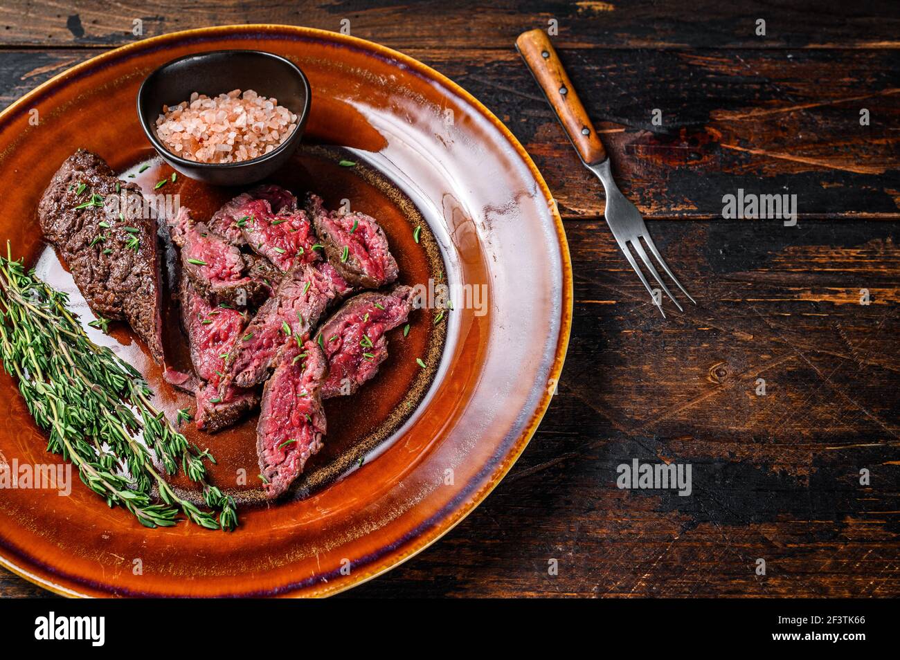 Medium rare Sliced grilled Onglet Hanging Tender meat beef steak on a ...
