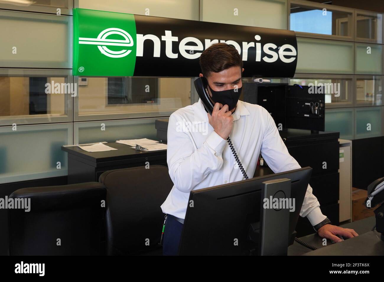 A customer service agent talks on a telephone at Enterprise Rent-A ...