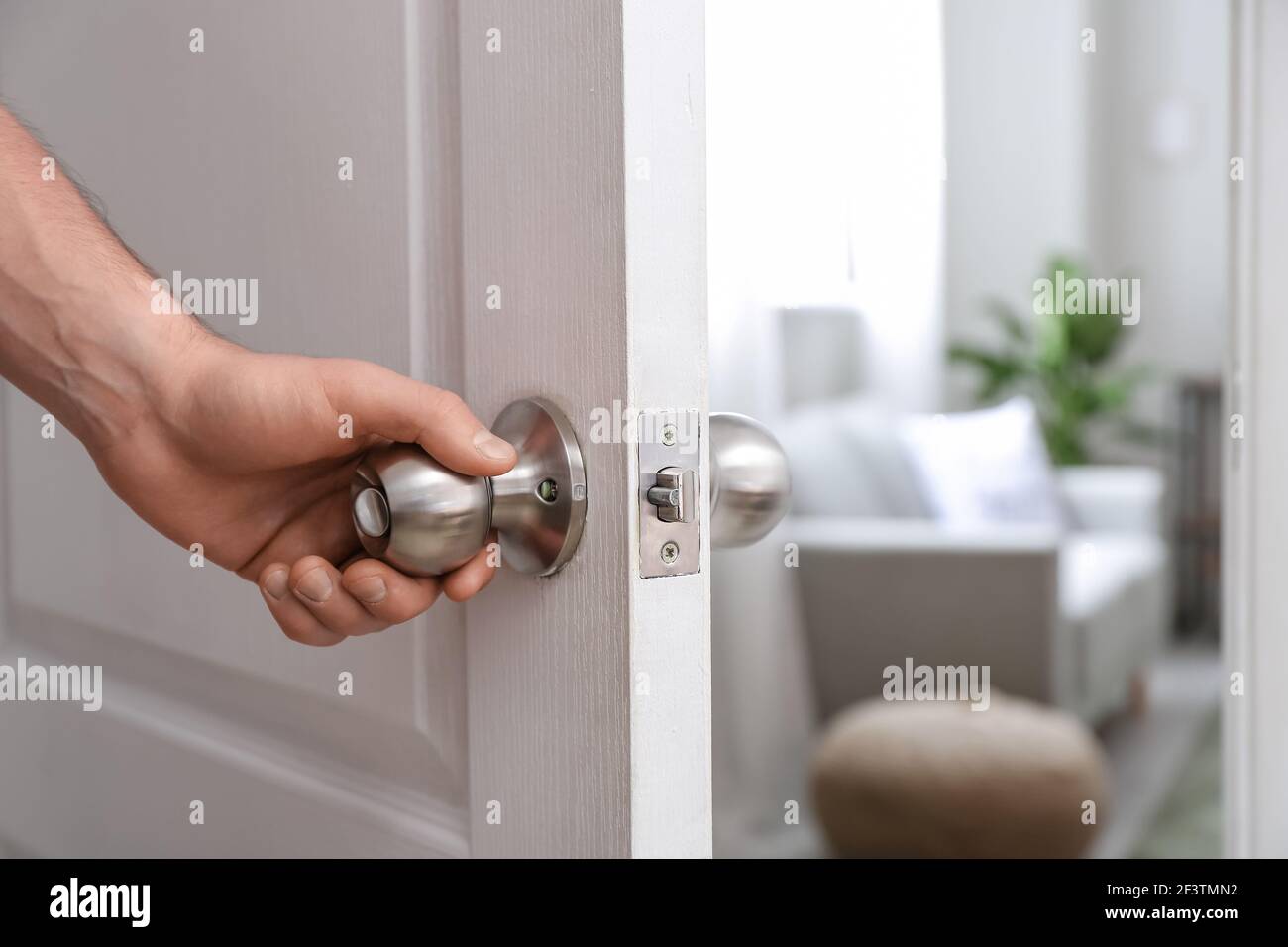 Hand opening door to living room hi-res stock photography and images ...