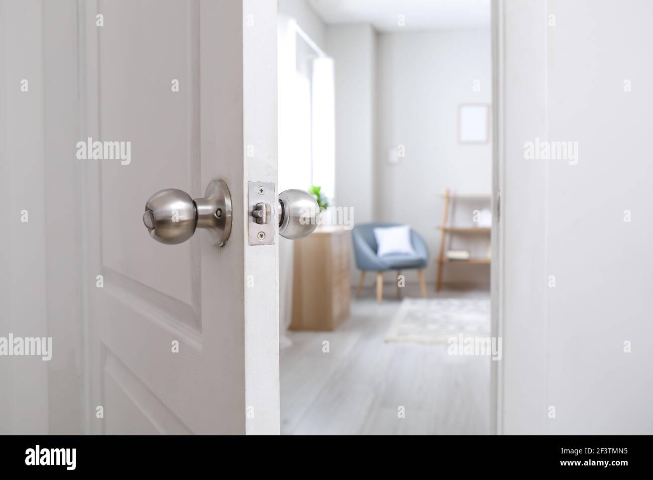 View of living room through open door Stock Photo - Alamy