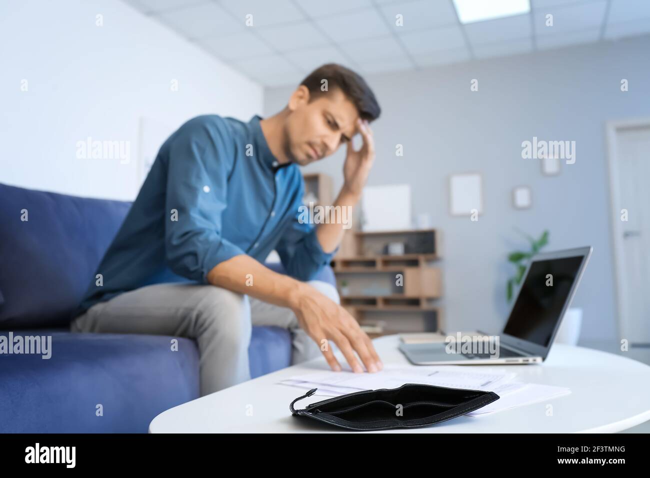 Portrait of stressed young man at home Stock Photo - Alamy
