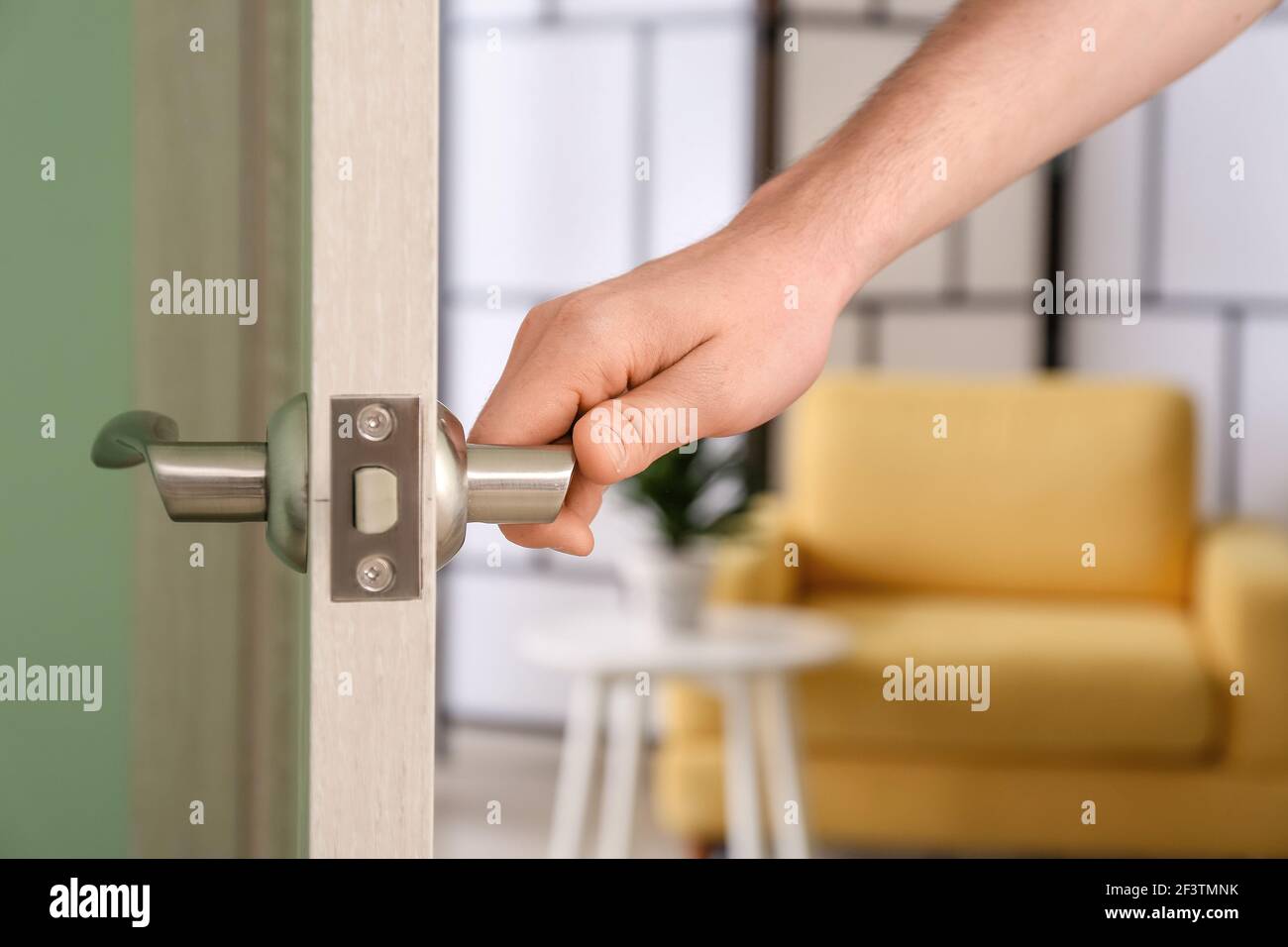 Hand opening door to living room hi-res stock photography and images ...