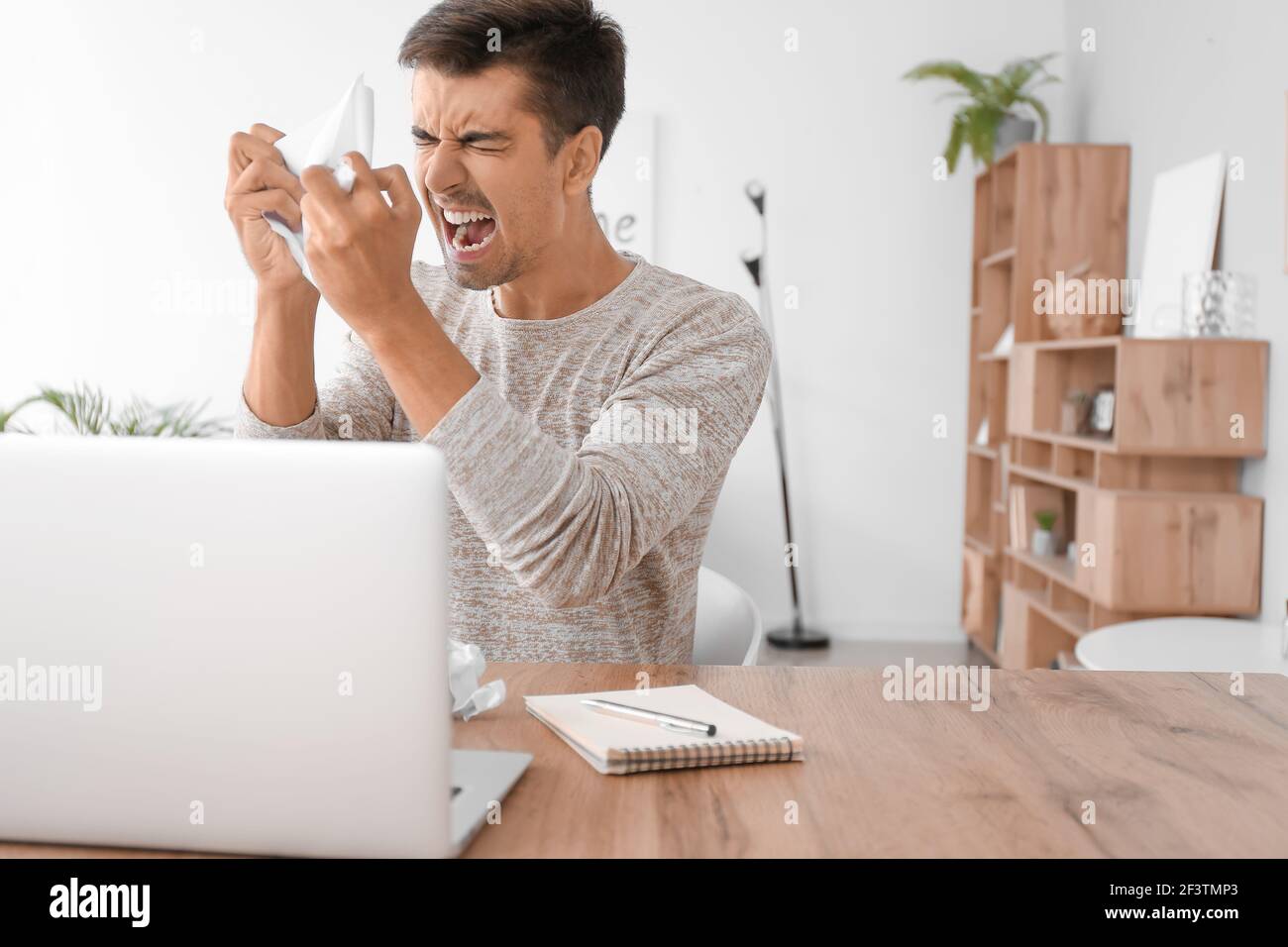 Portrait of stressed young man at home Stock Photo - Alamy