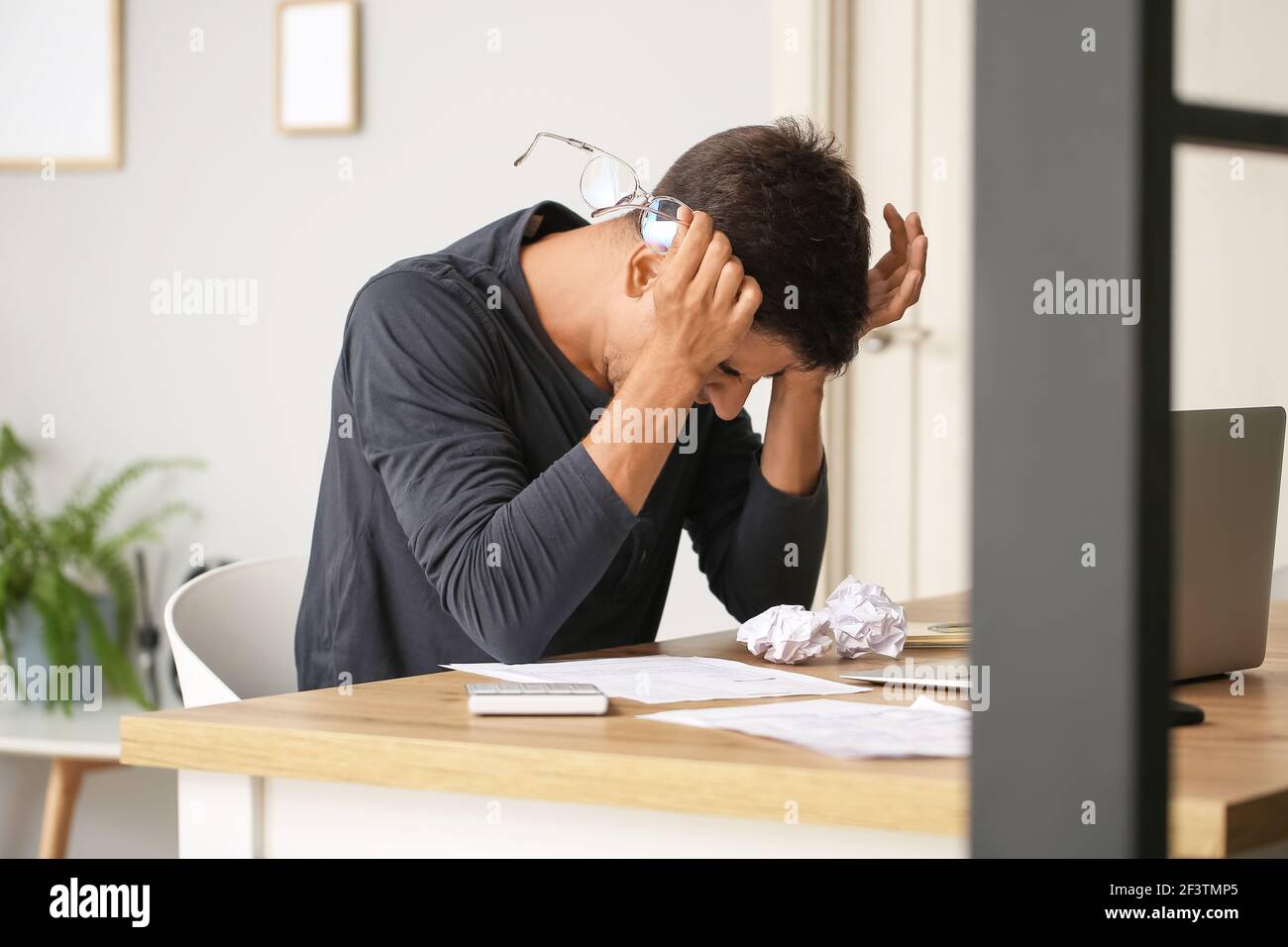 Portrait of stressed young man at home Stock Photo - Alamy