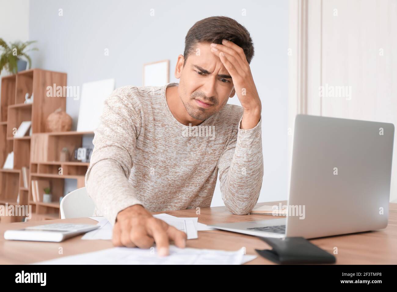 Portrait of stressed young man at home Stock Photo - Alamy