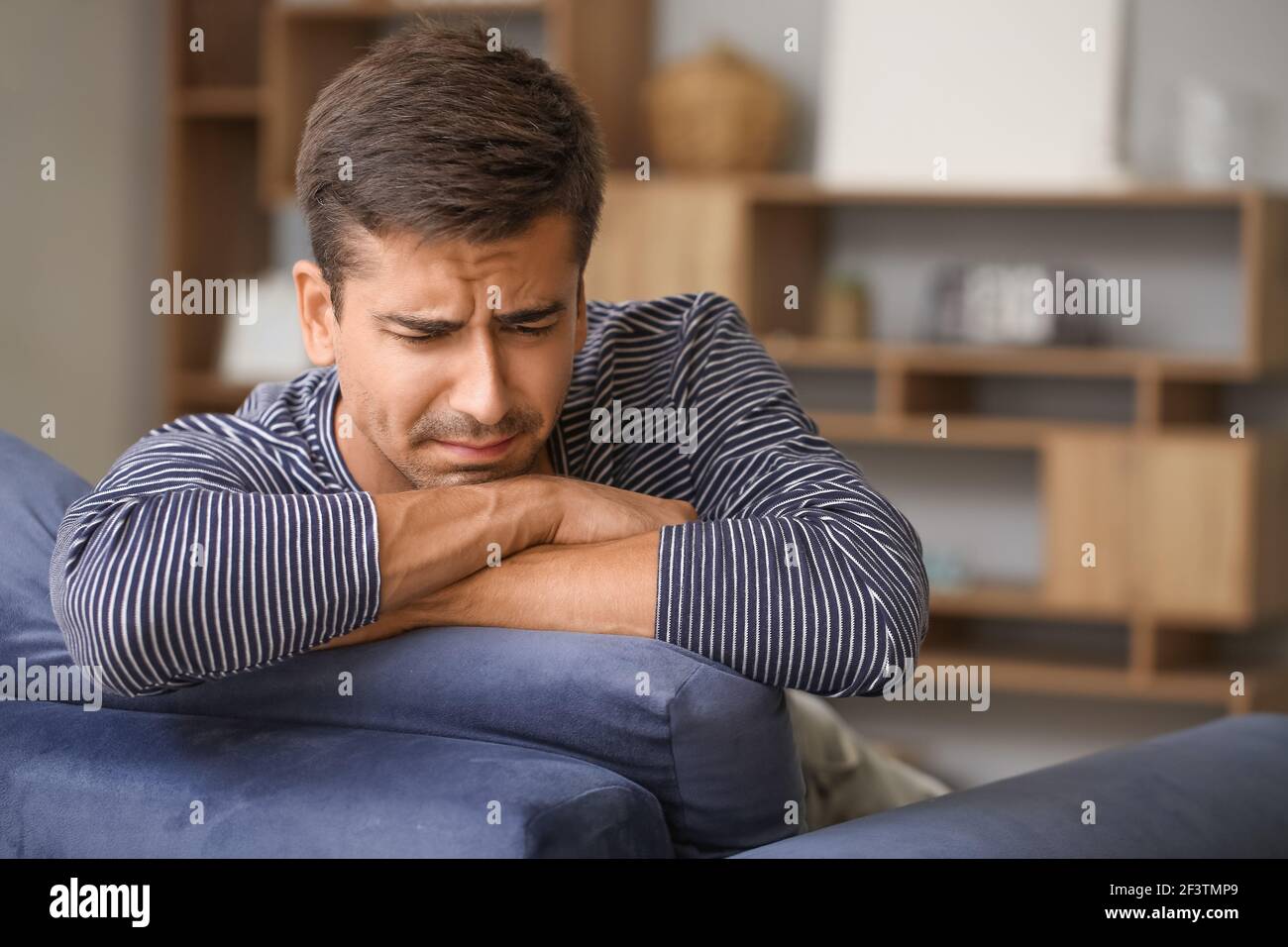 Portrait of stressed young man at home Stock Photo - Alamy