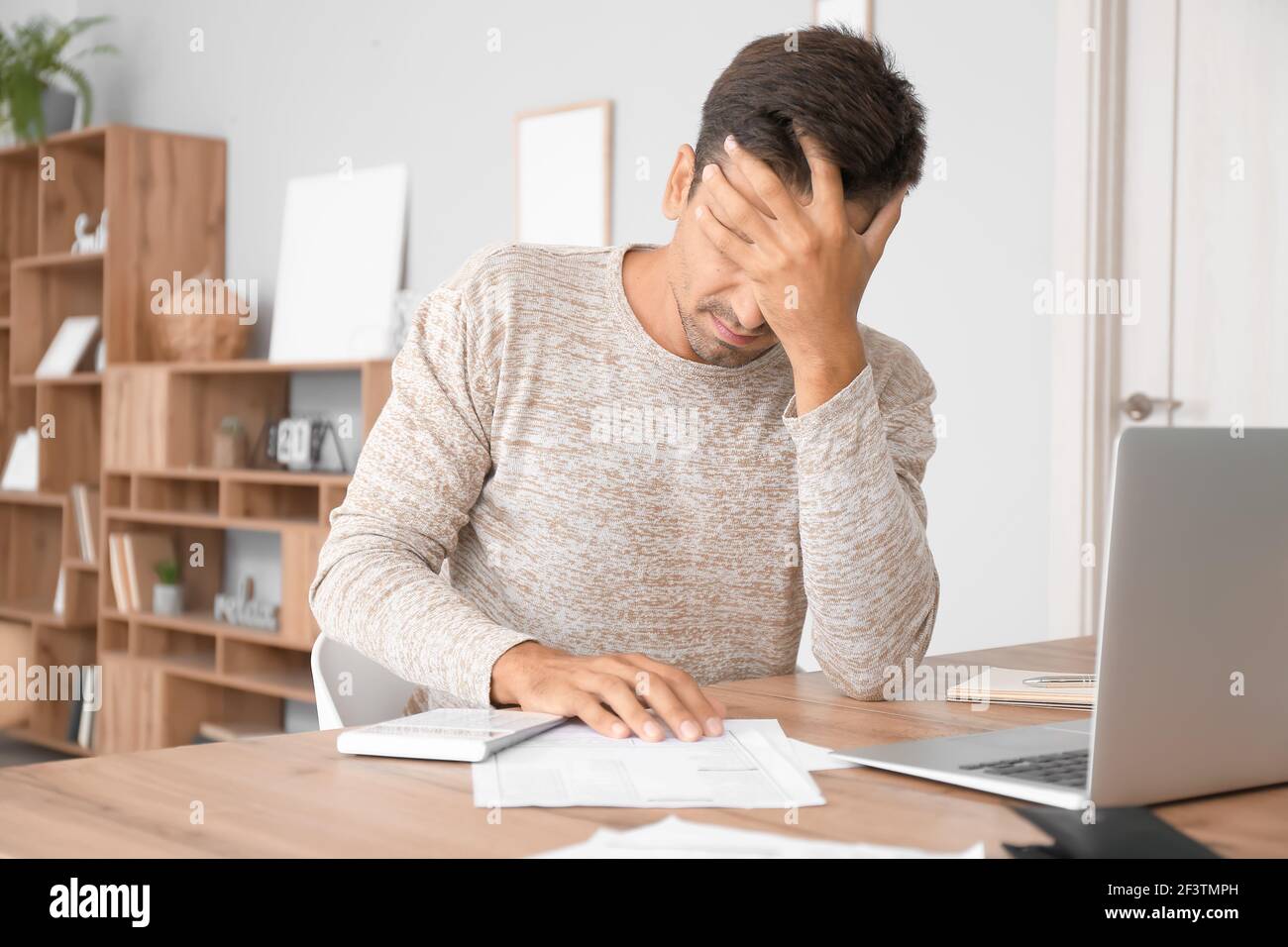 Portrait of stressed young man at home Stock Photo - Alamy