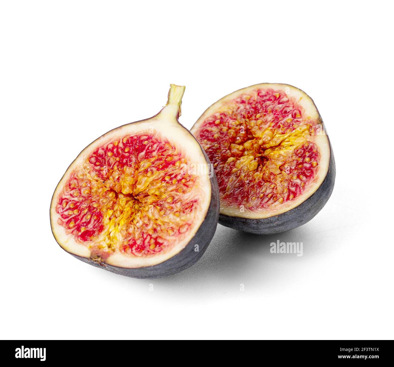 Cut fig fruit on white background Stock Photo - Alamy