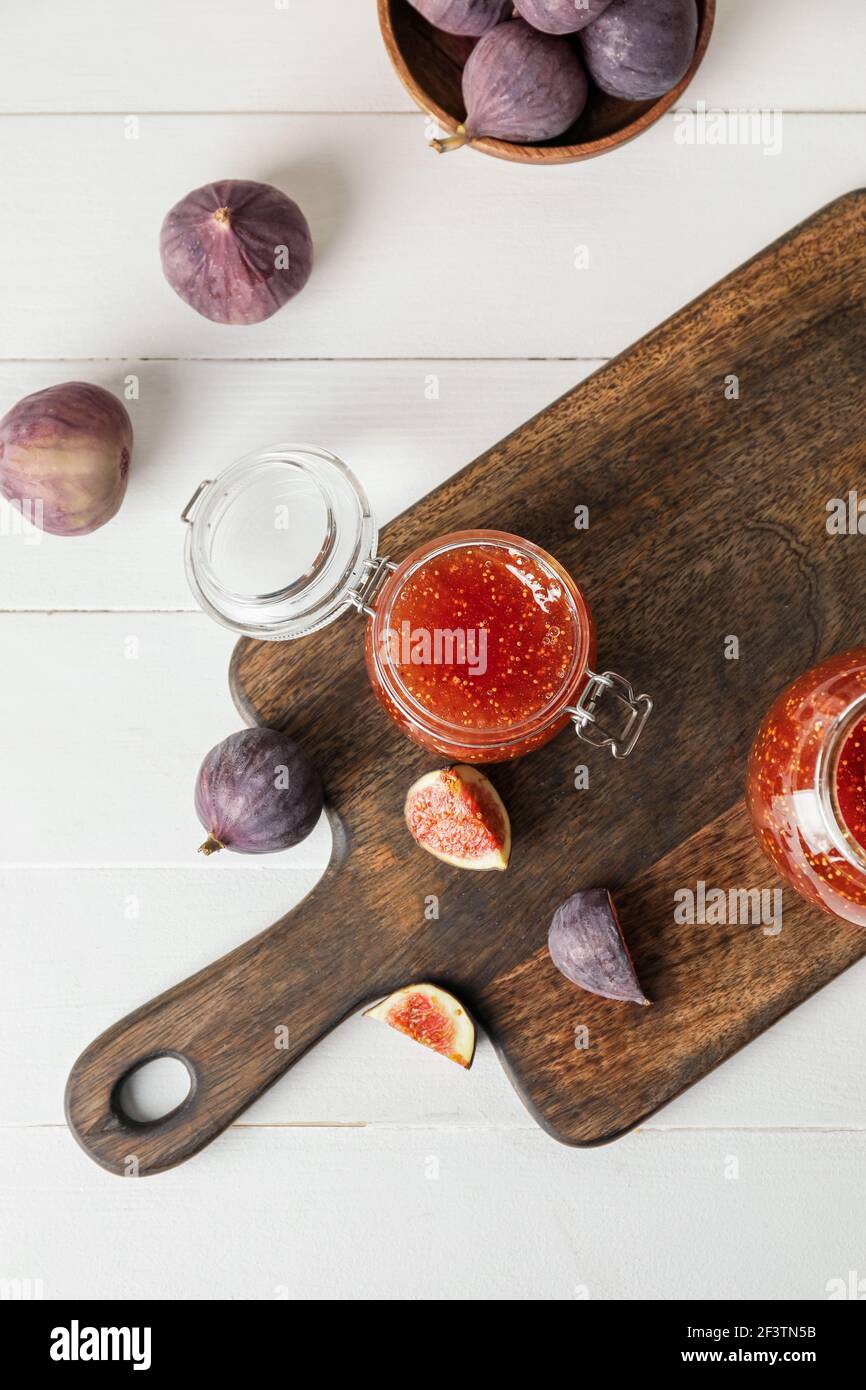 Jar of sweet fig jam on white table Stock Photo - Alamy