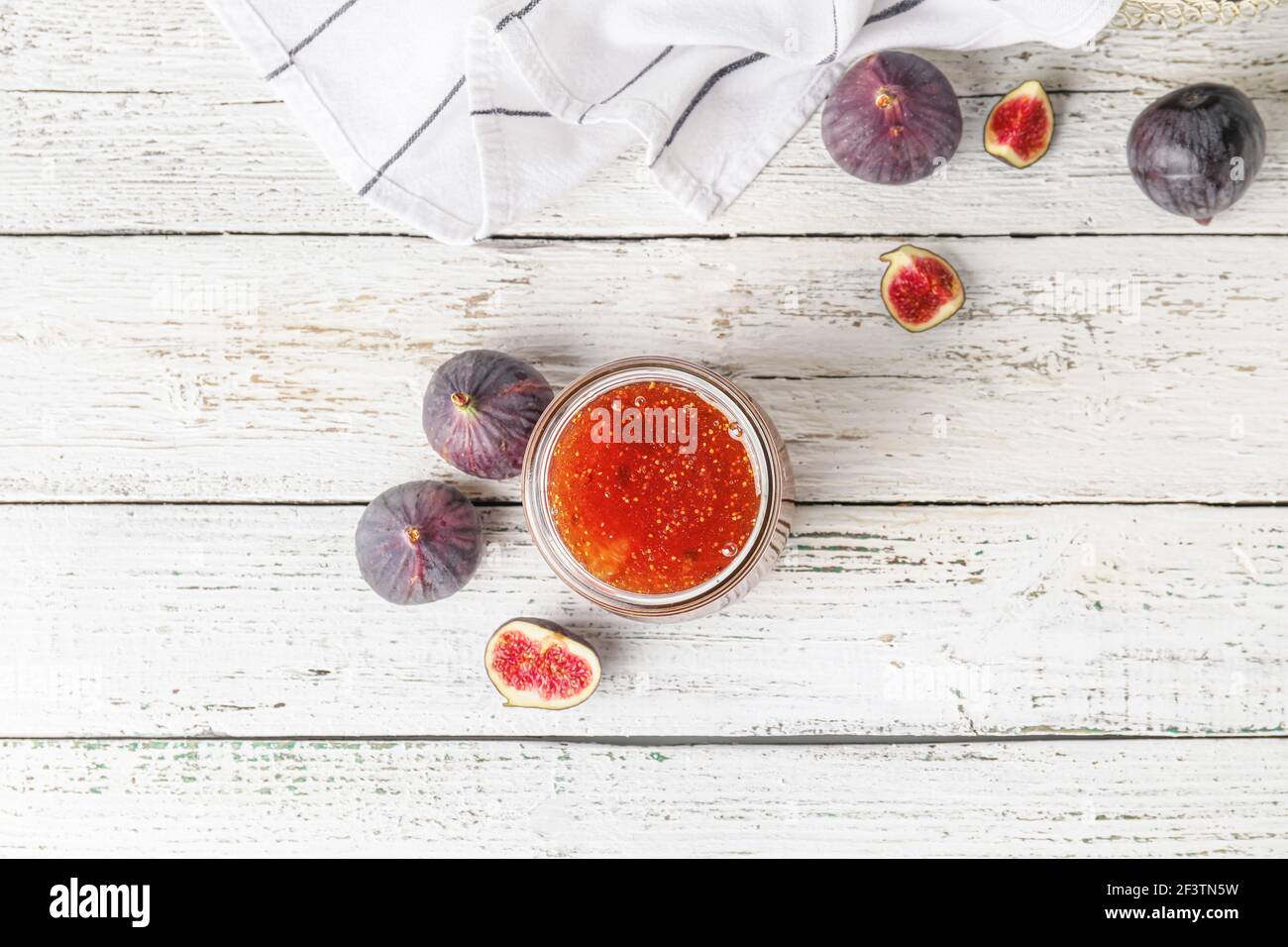 Jar of sweet fig jam on white wooden table Stock Photo - Alamy