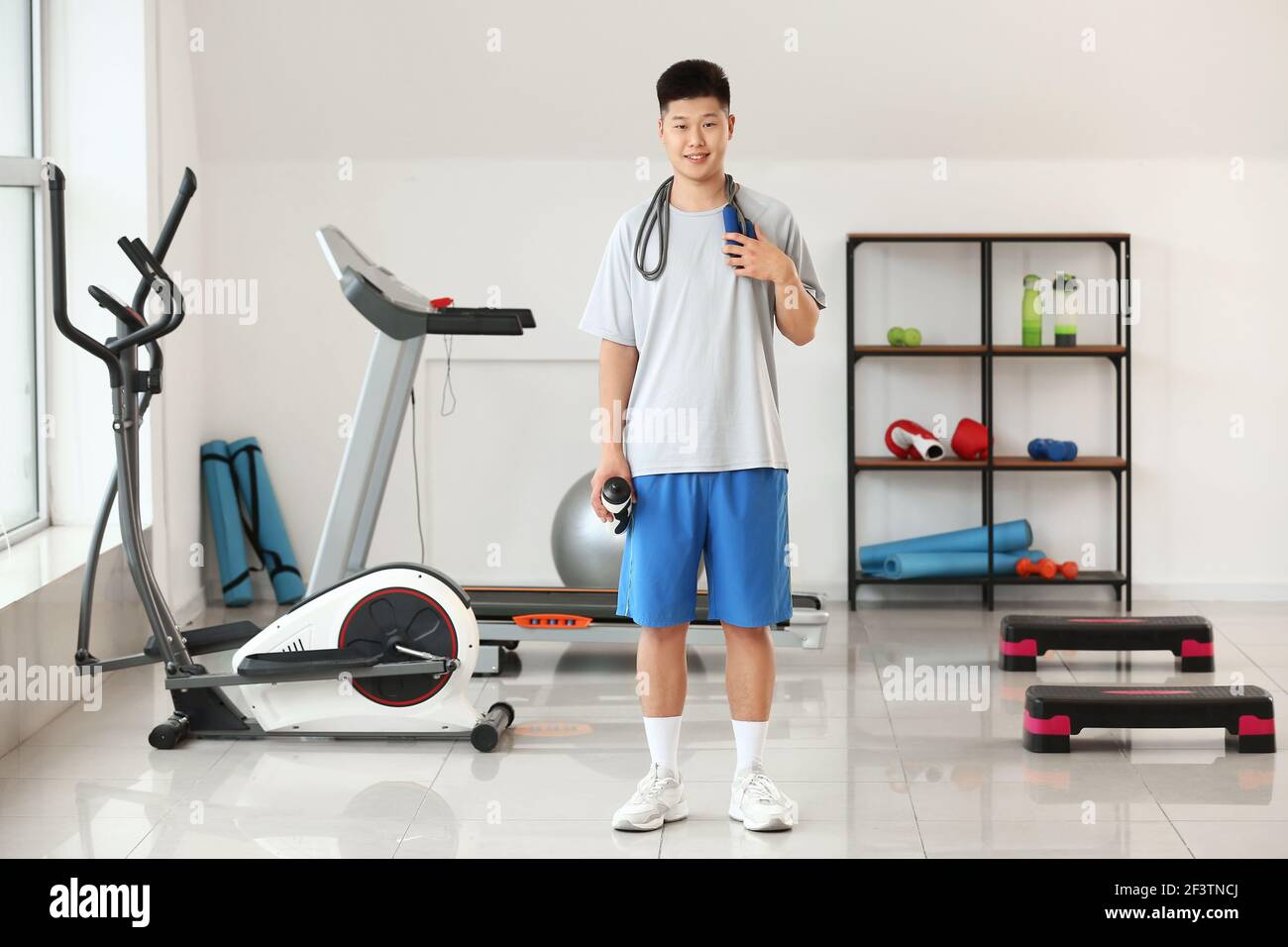 Male Asian fitness instructor in gym Stock Photo - Alamy