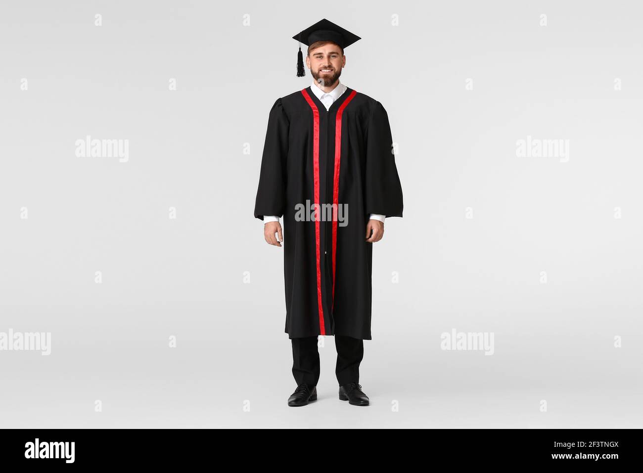 Young man in bachelor robe on white background Stock Photo - Alamy
