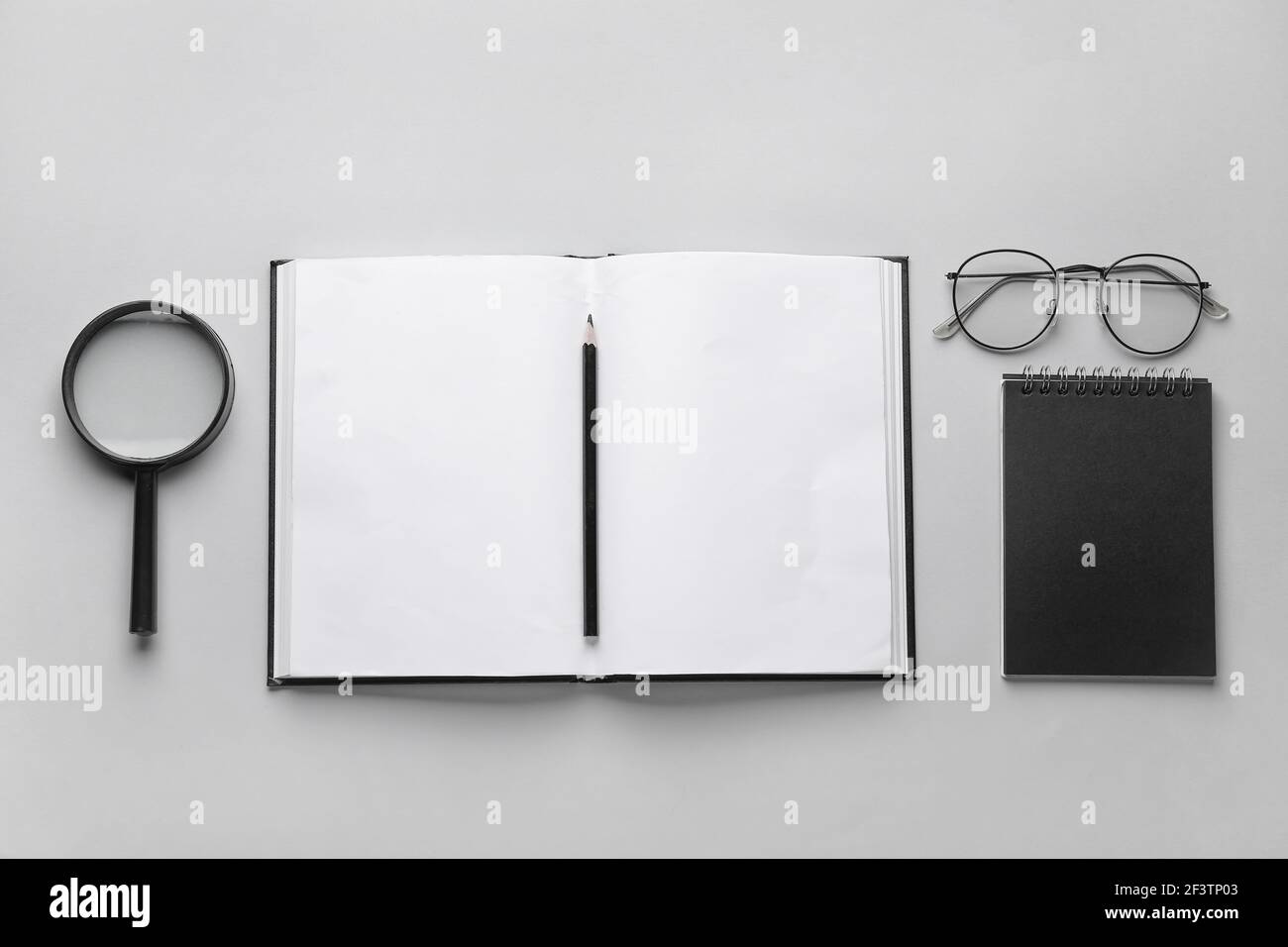 Composition with blank book on light background Stock Photo - Alamy