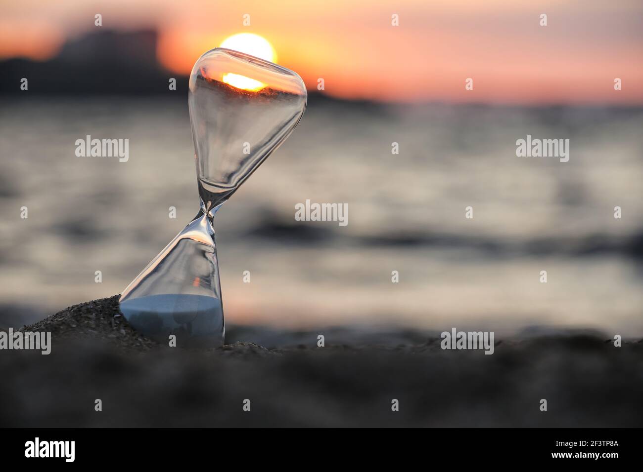 Stylish hourglass on sand outdoors Stock Photo - Alamy