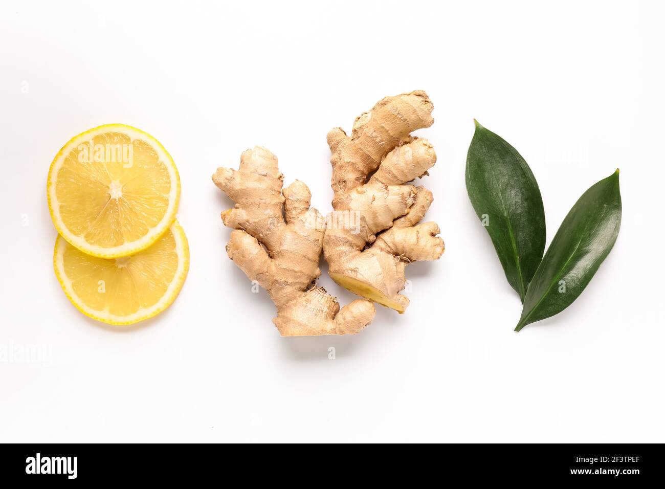 Fresh ginger and lemon on white background Stock Photo - Alamy