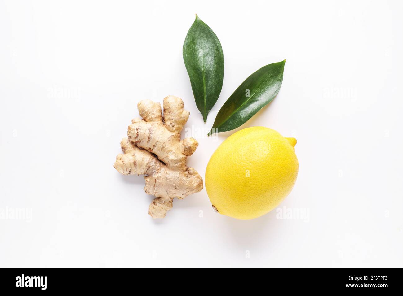 Fresh ginger and lemon on white background Stock Photo - Alamy