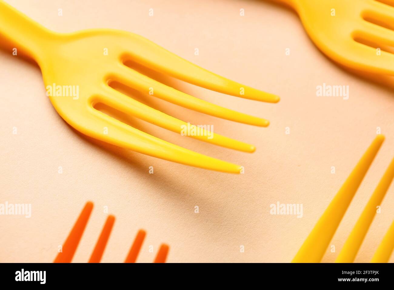Plastic forks on color background Stock Photo - Alamy