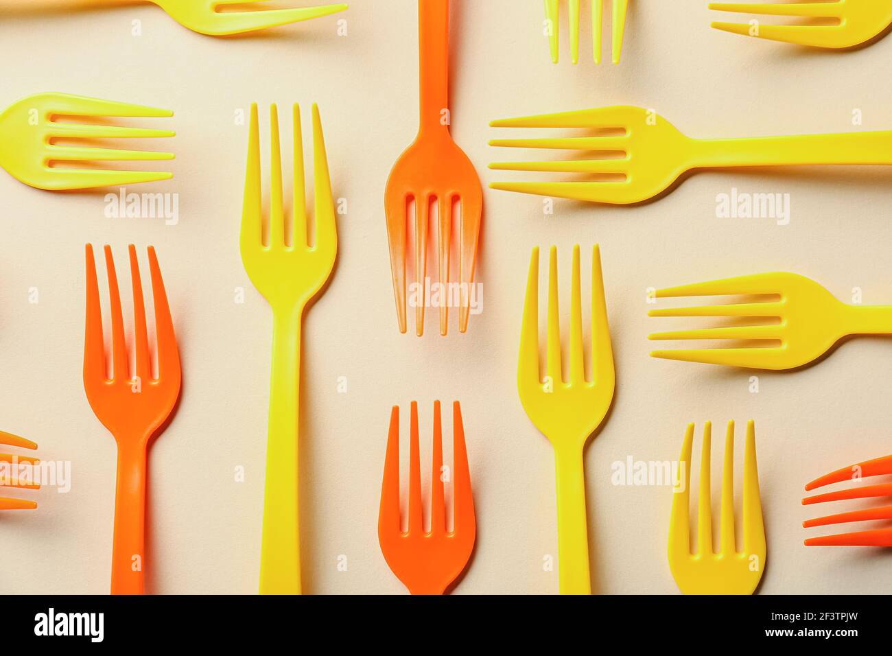 Plastic forks on color background Stock Photo - Alamy