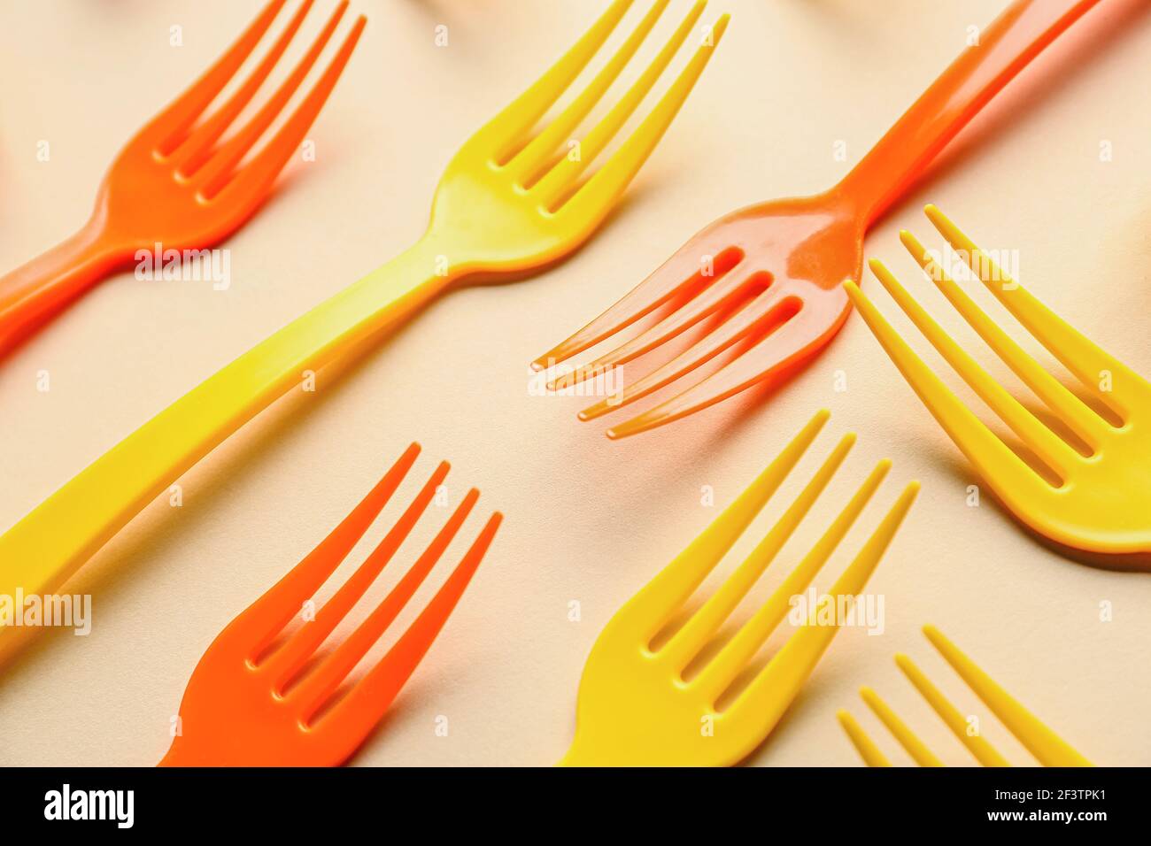 Plastic forks on color background Stock Photo - Alamy