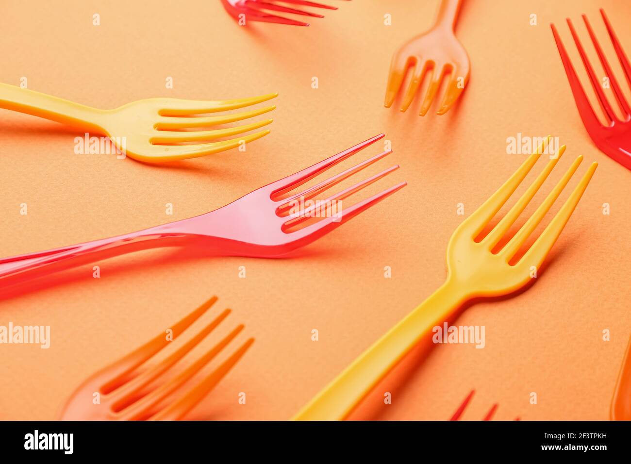Plastic forks on color background Stock Photo - Alamy