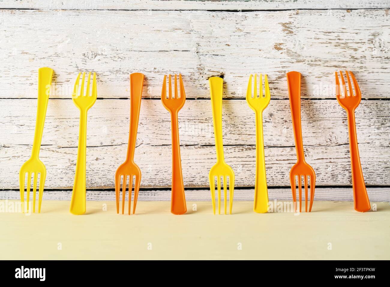 Plastic forks on color table Stock Photo - Alamy