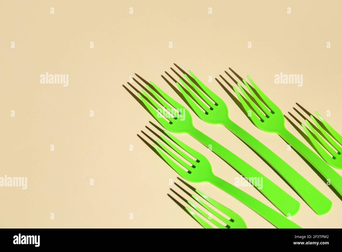 Plastic forks on color background Stock Photo - Alamy