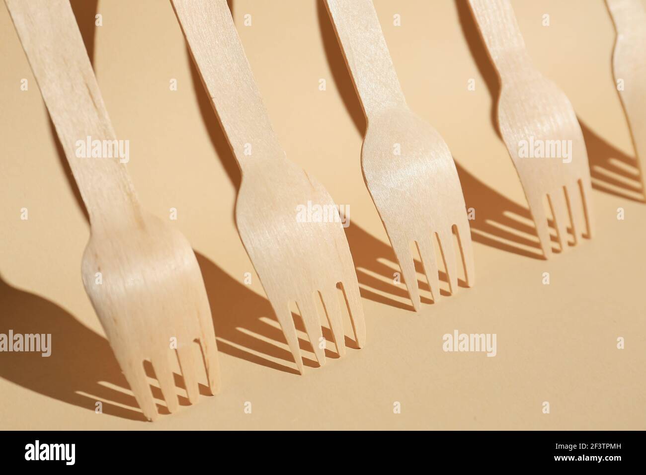 Wooden forks on color background Stock Photo - Alamy