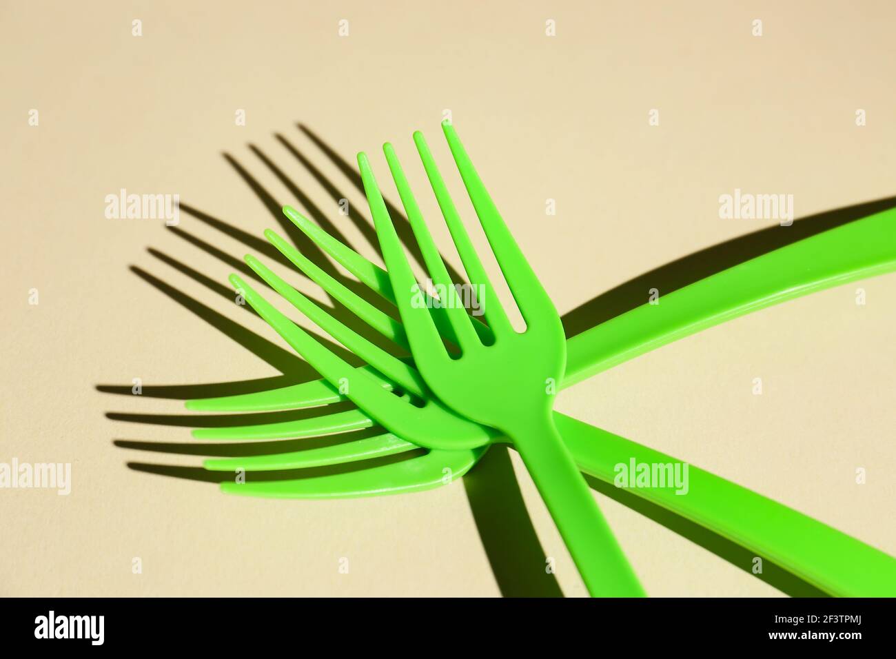 Plastic forks on color background Stock Photo - Alamy