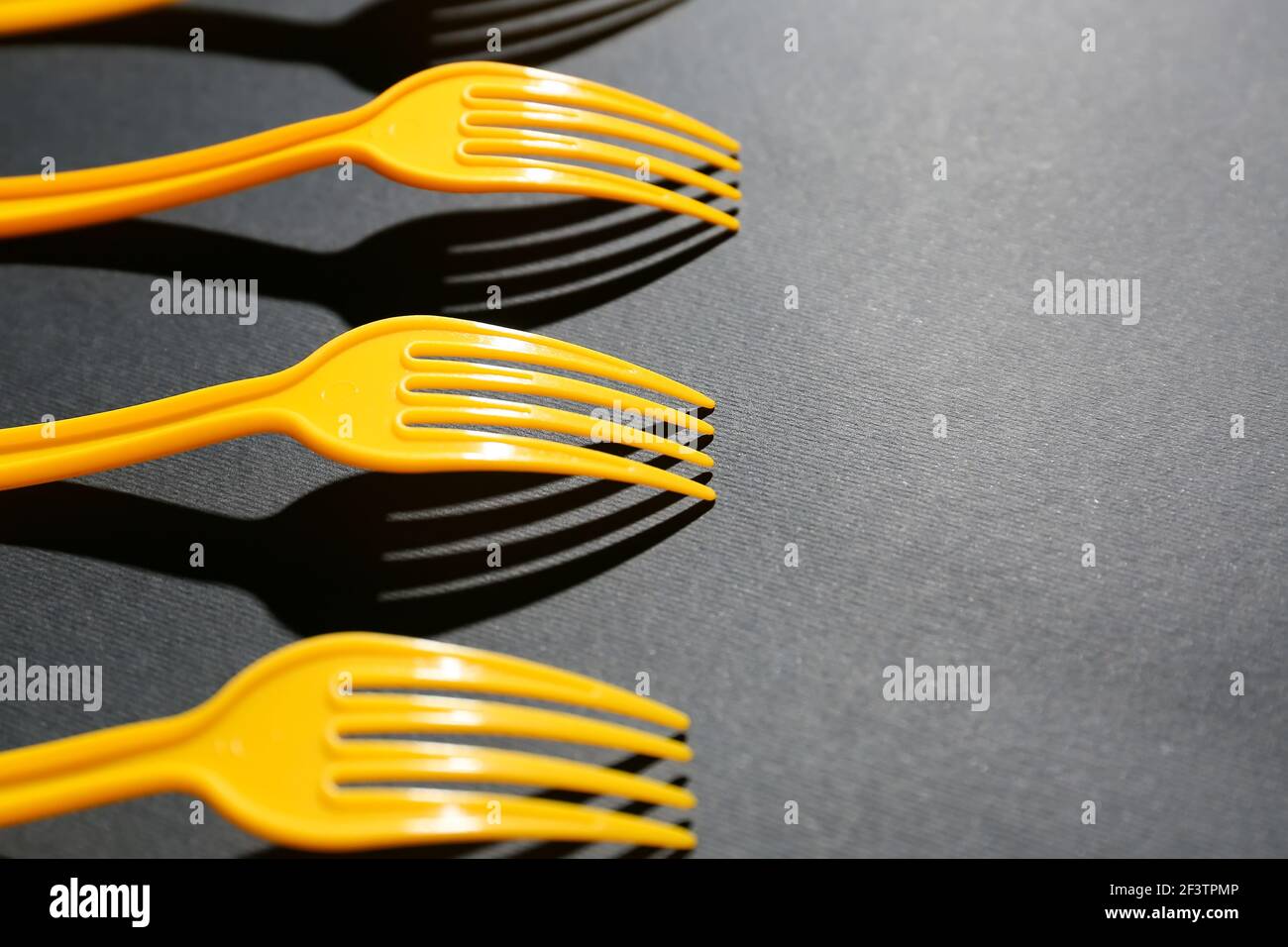 Plastic forks on dark background Stock Photo - Alamy