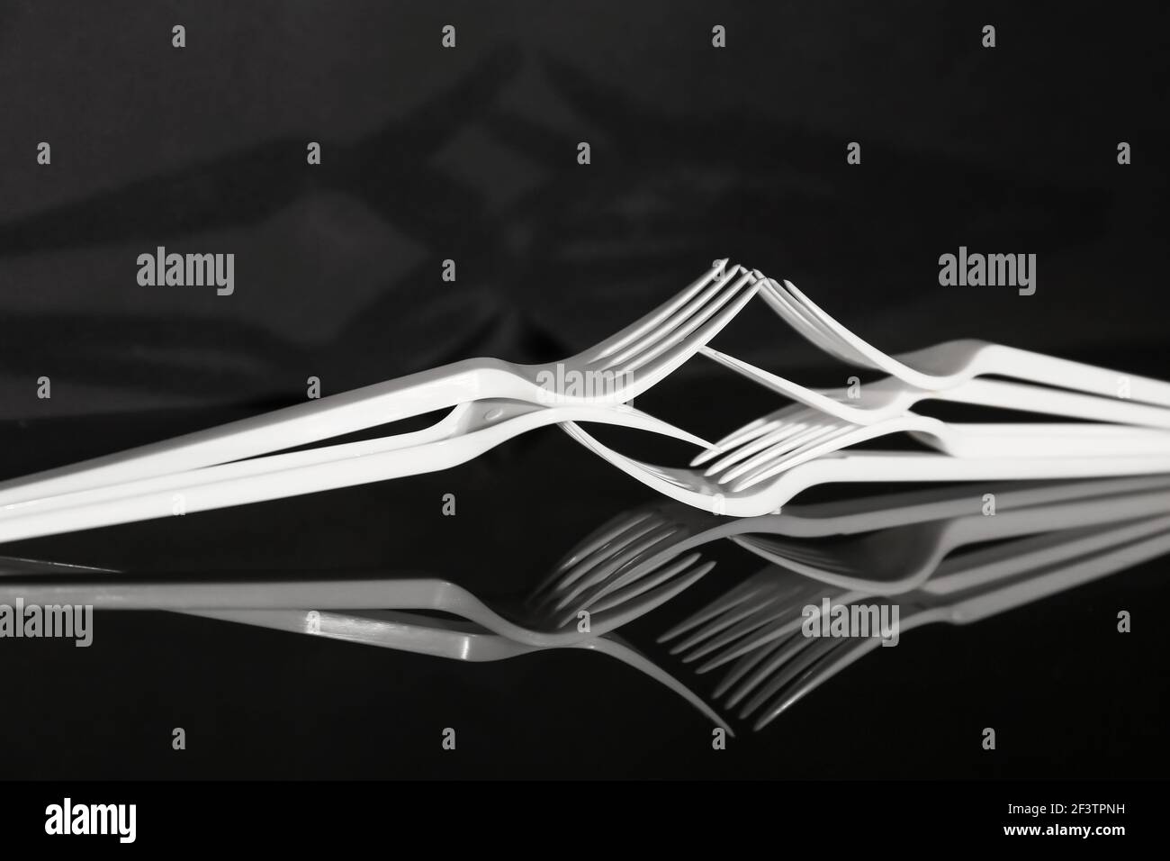 Plastic forks on dark background Stock Photo - Alamy