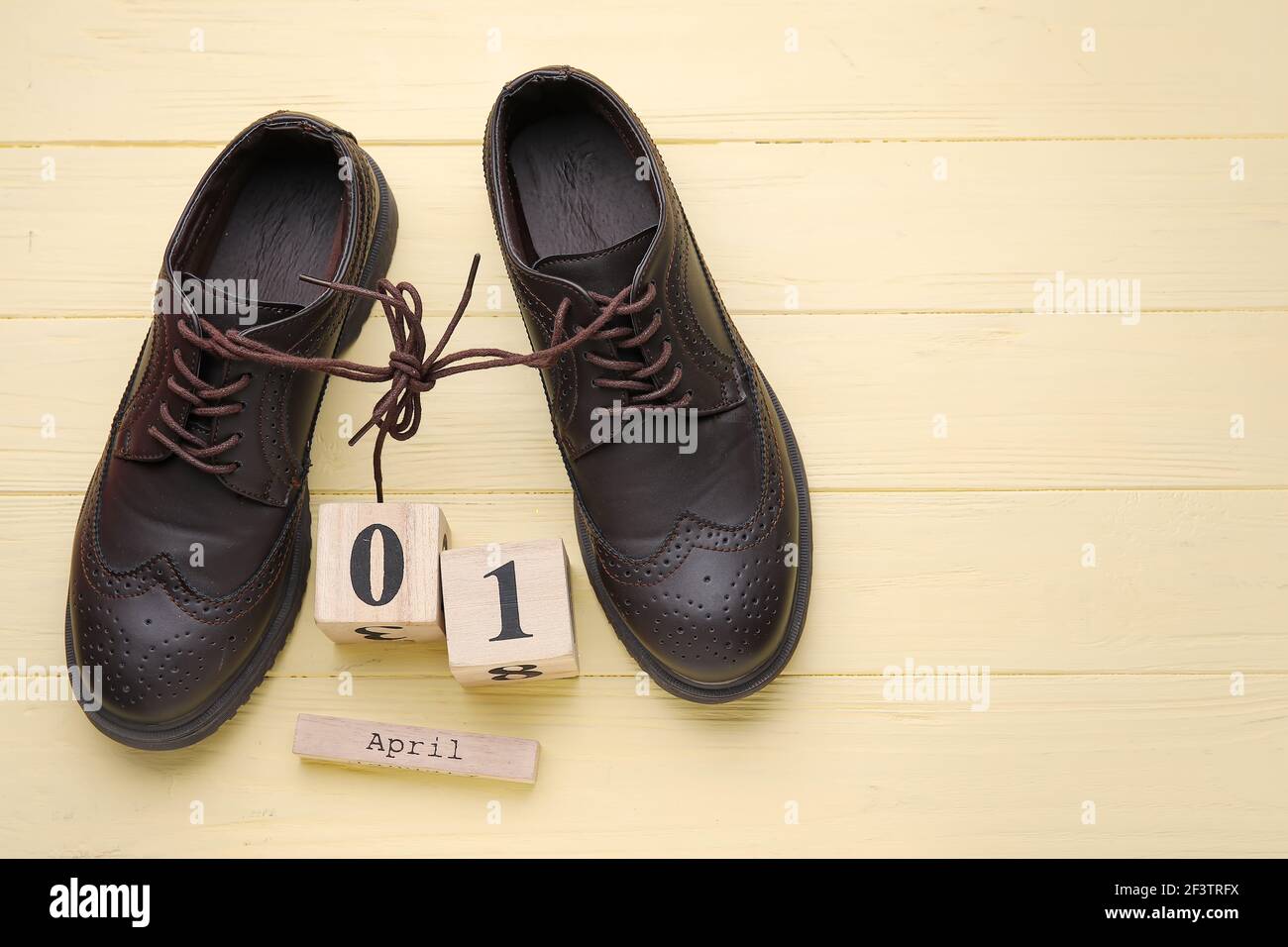 Shoes with tied laces and calendar with date of April Fools Day on ...