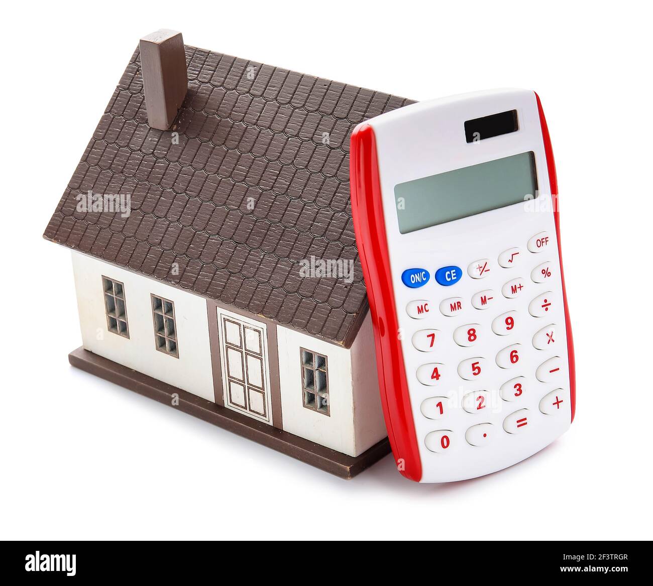Calculator with model of house on white background Stock Photo - Alamy