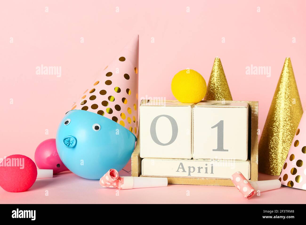 Calendar with date of April Fools Day and party decor on color ...