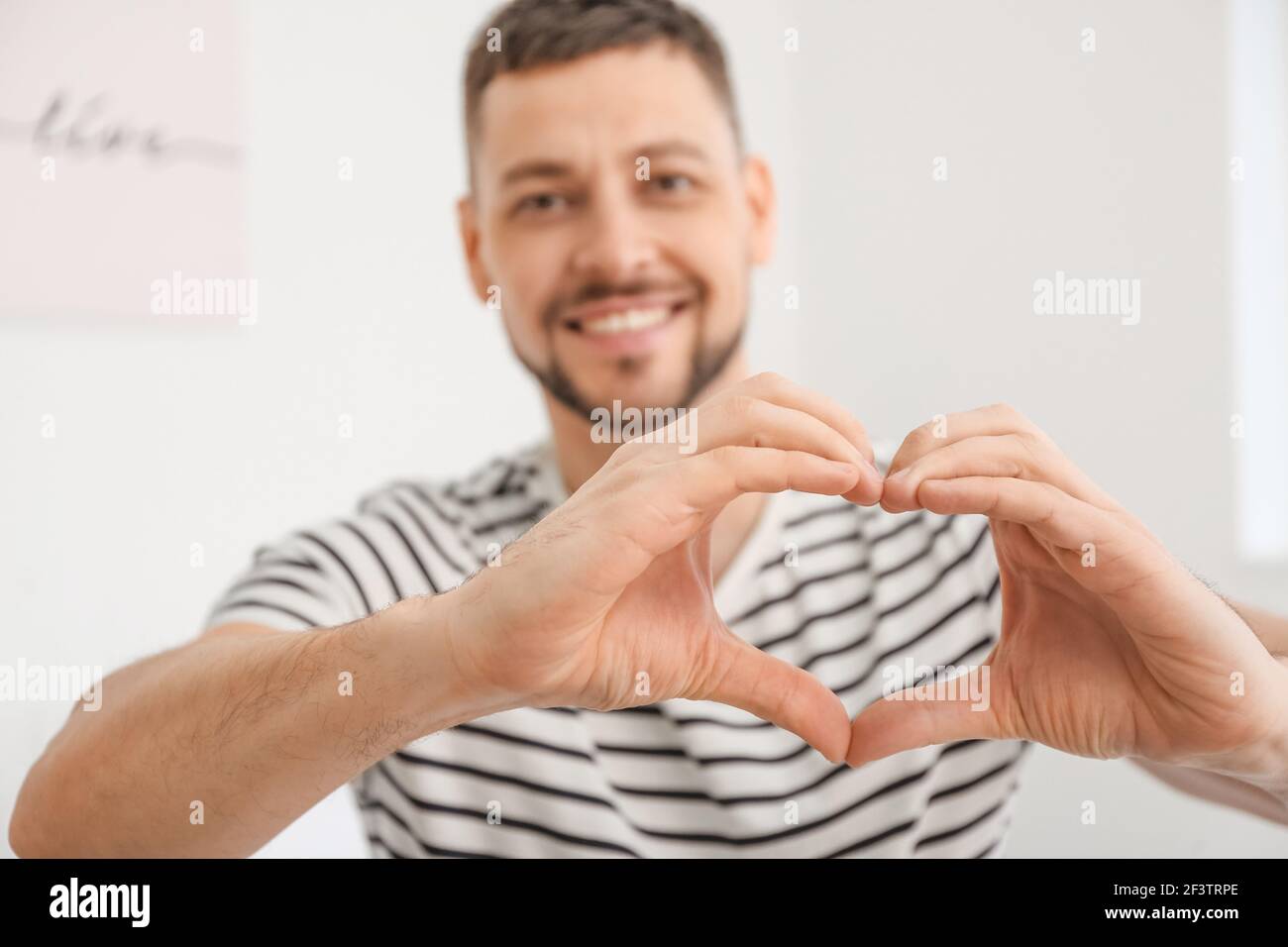 Man making heart with his hands at home Stock Photo - Alamy