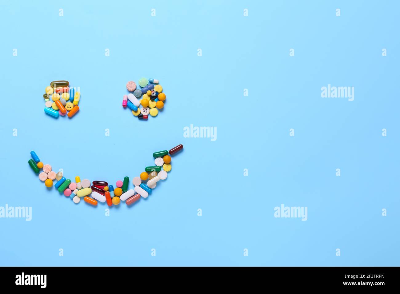 Happy face made of different drugs on color background. Addiction ...