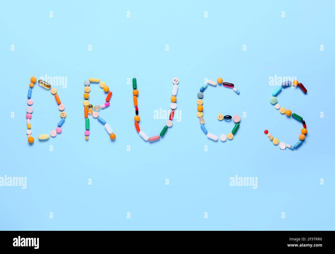 Word DRUGS made of different pills on color background. Addiction ...