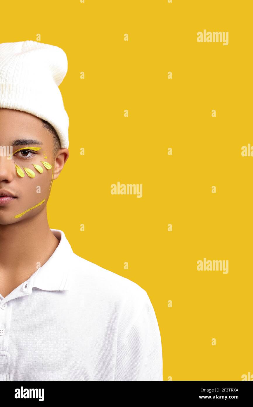 Creative portrait of handsome young man on color background Stock Photo ...