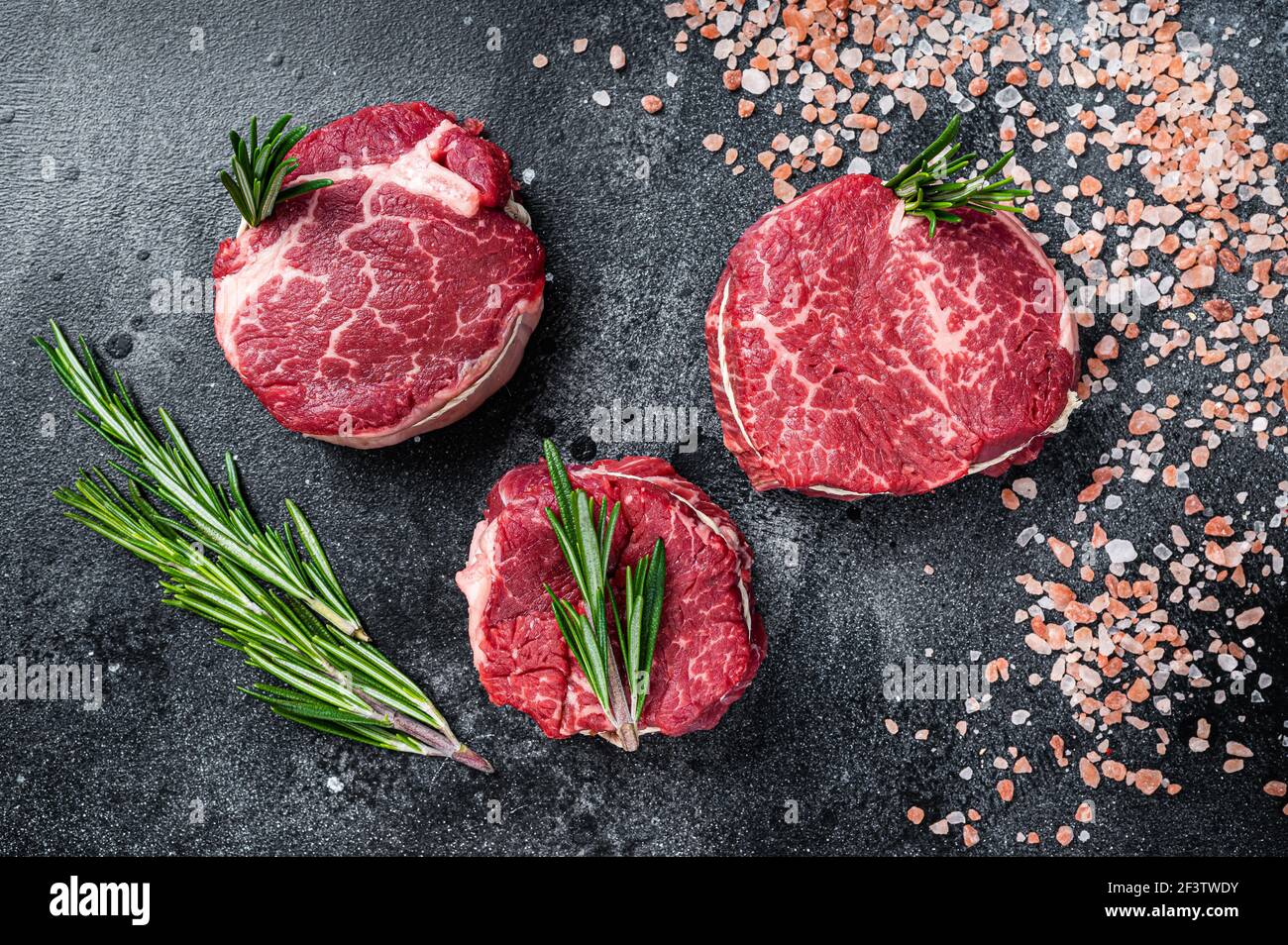 Fillet Mignon tenderloin raw meat beef steaks on butchery table. Black ...