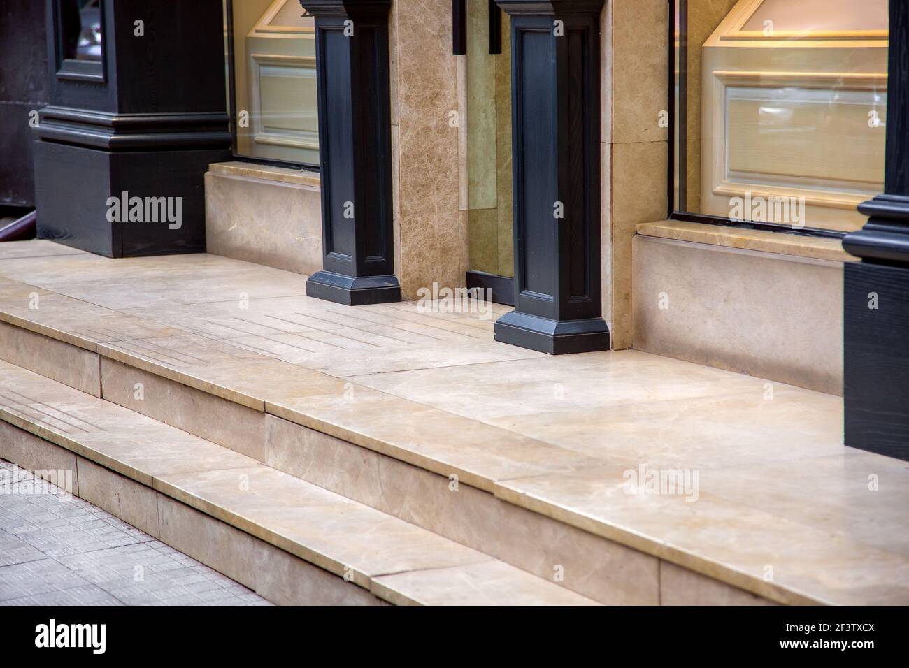 beige marble threshold with steps at entrance to glass door of ...