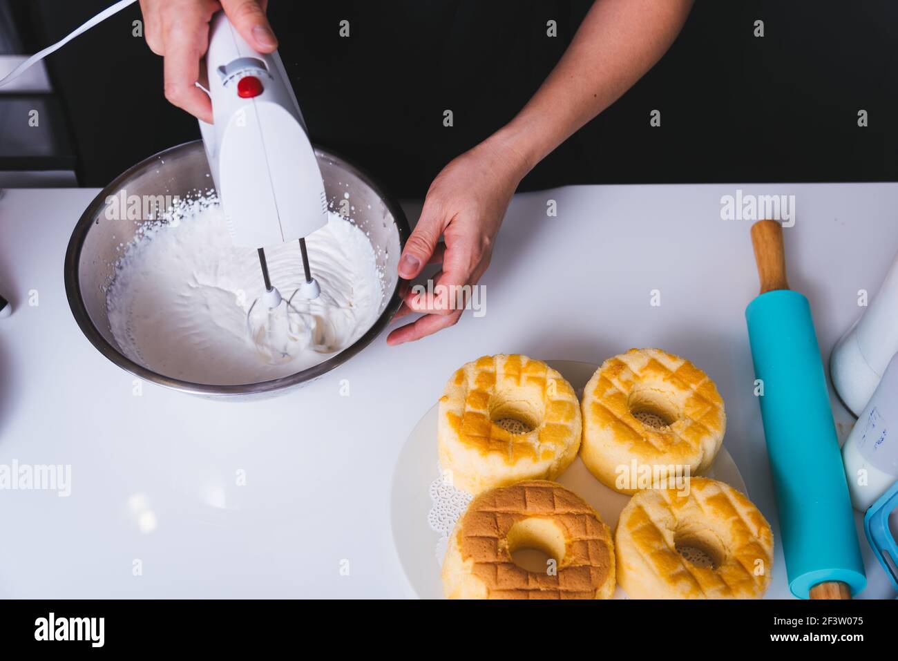 Woman beat dough mixer by machine in bowl at her kitchen Stock Photo ...