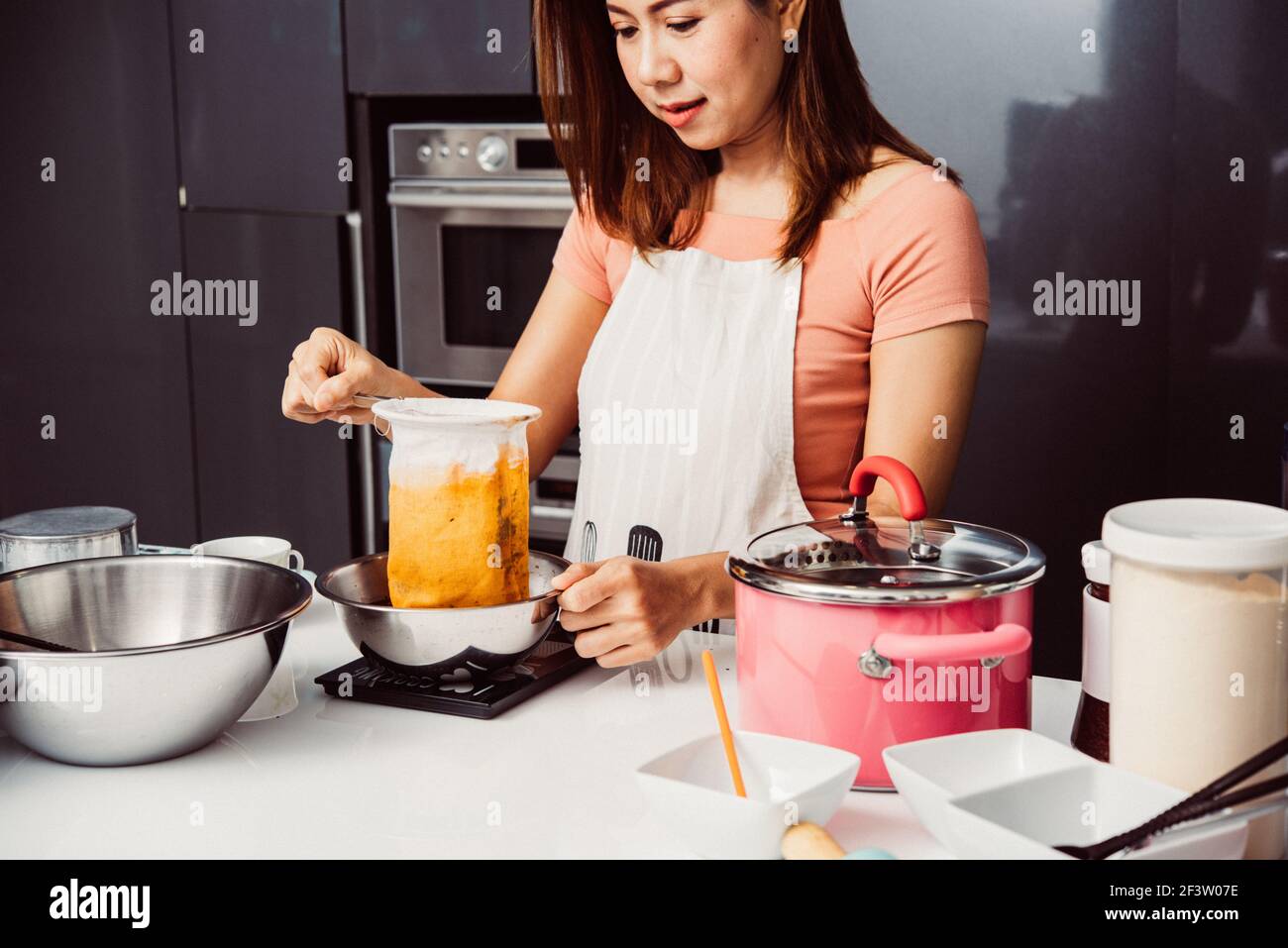 Woman girl in kitchen cooking pouring drip hot thai tea, food sweet ...