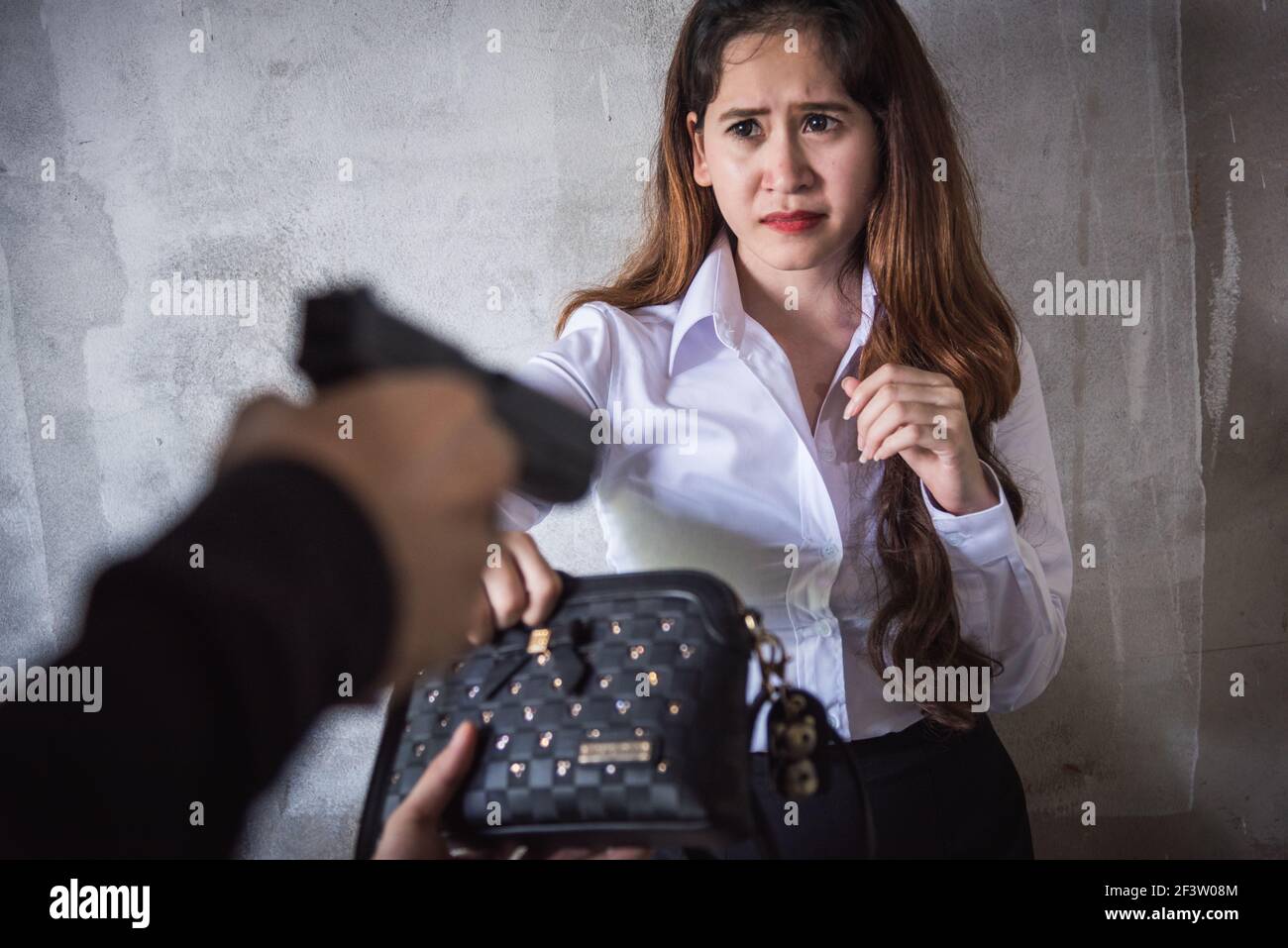 The man bandit robber snatched money bag by gun from a woman who walked ...