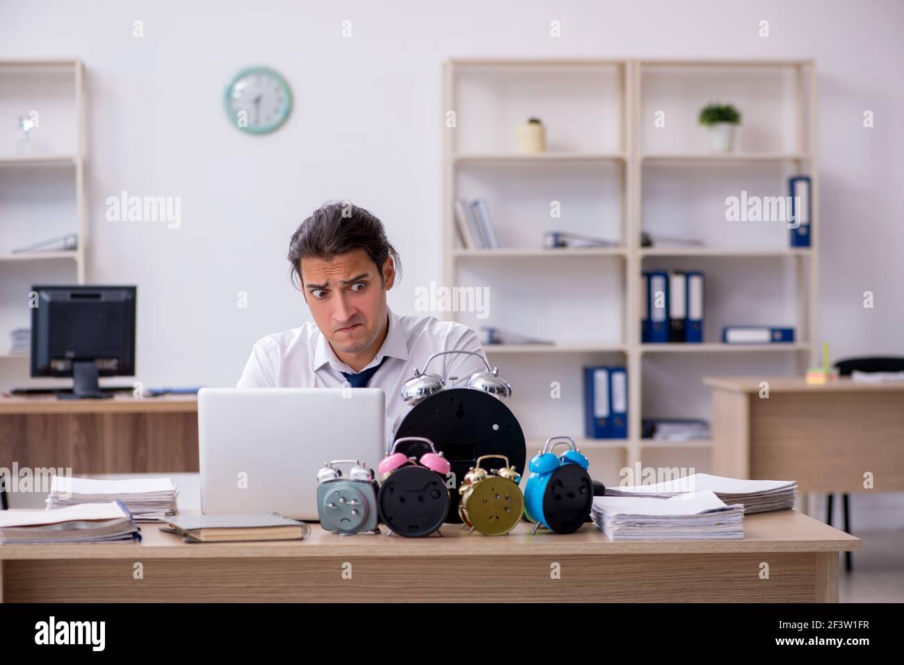 Young employee afraid of missing deadline at workplace Stock Photo - Alamy