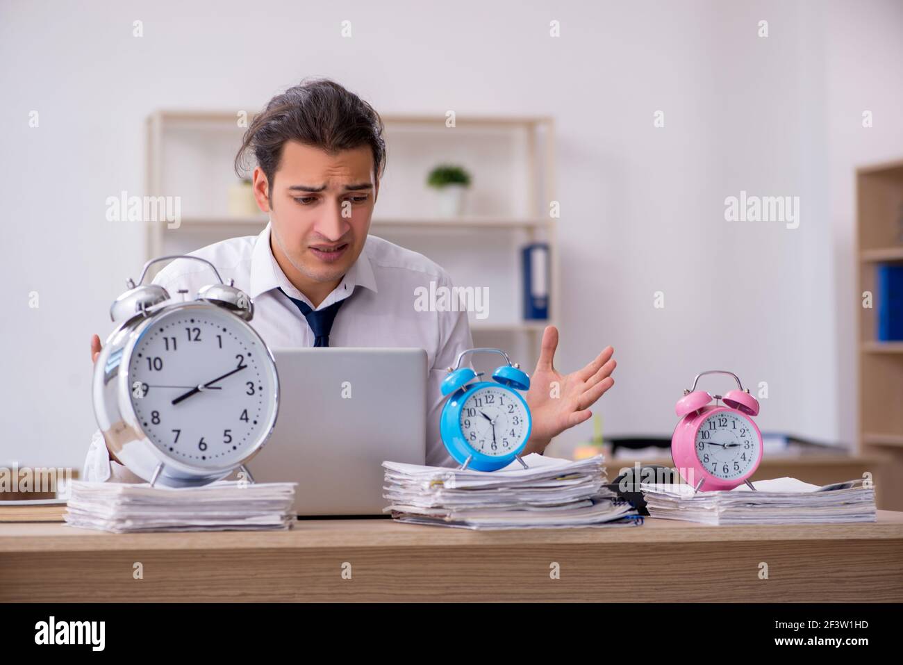 Young employee afraid of missing deadline at workplace Stock Photo - Alamy